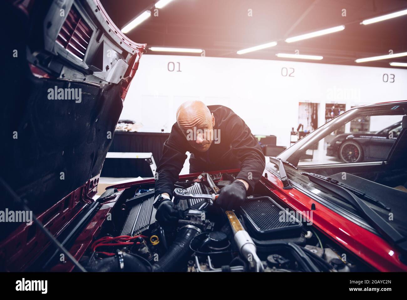 Man repairing car engine with his tools Stock Photo - Alamy