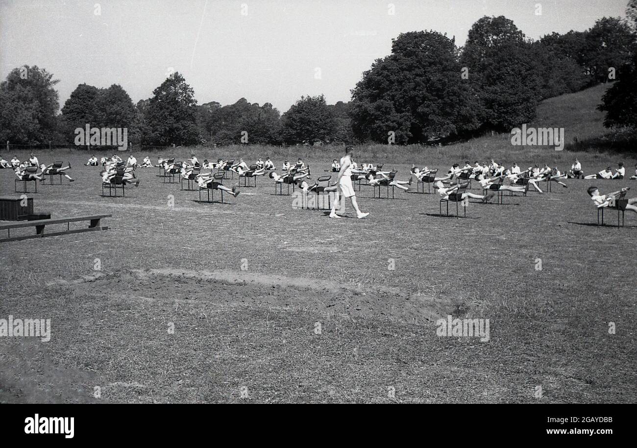 1950s, historical, a group of schoolboys outside in a field at a PE ...
