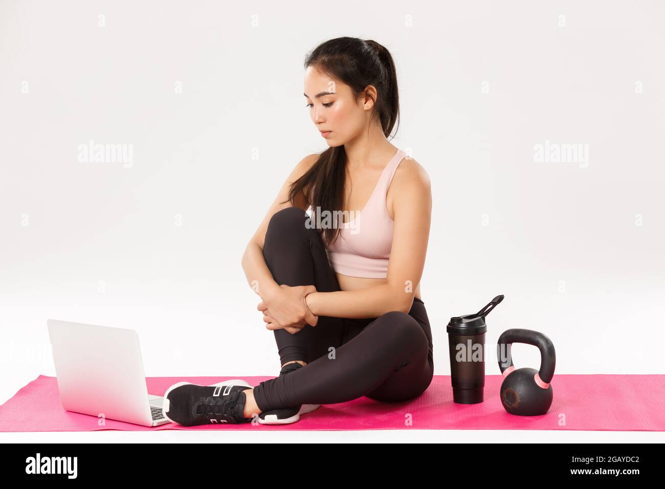Portrait of focused cute asian fitness girl workout from home, sitting ...