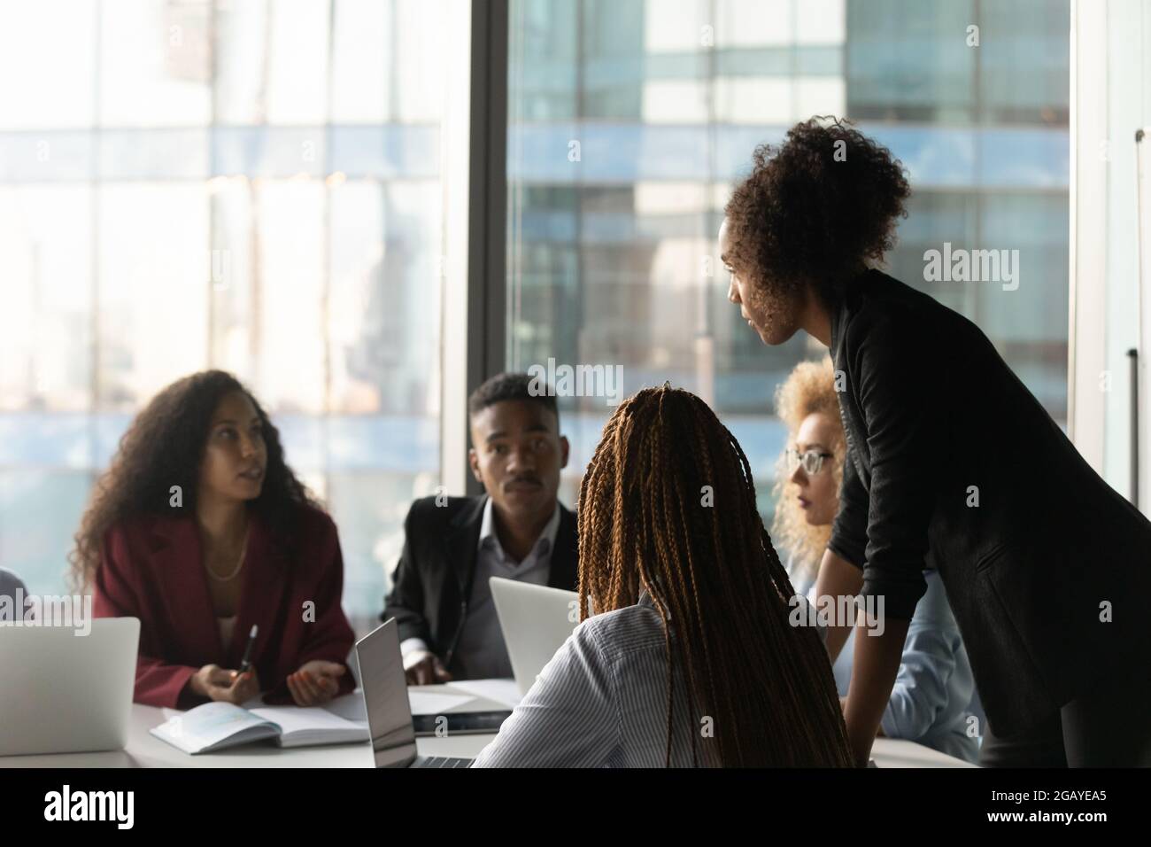 Motivated young african american people discussing project Stock Photo ...