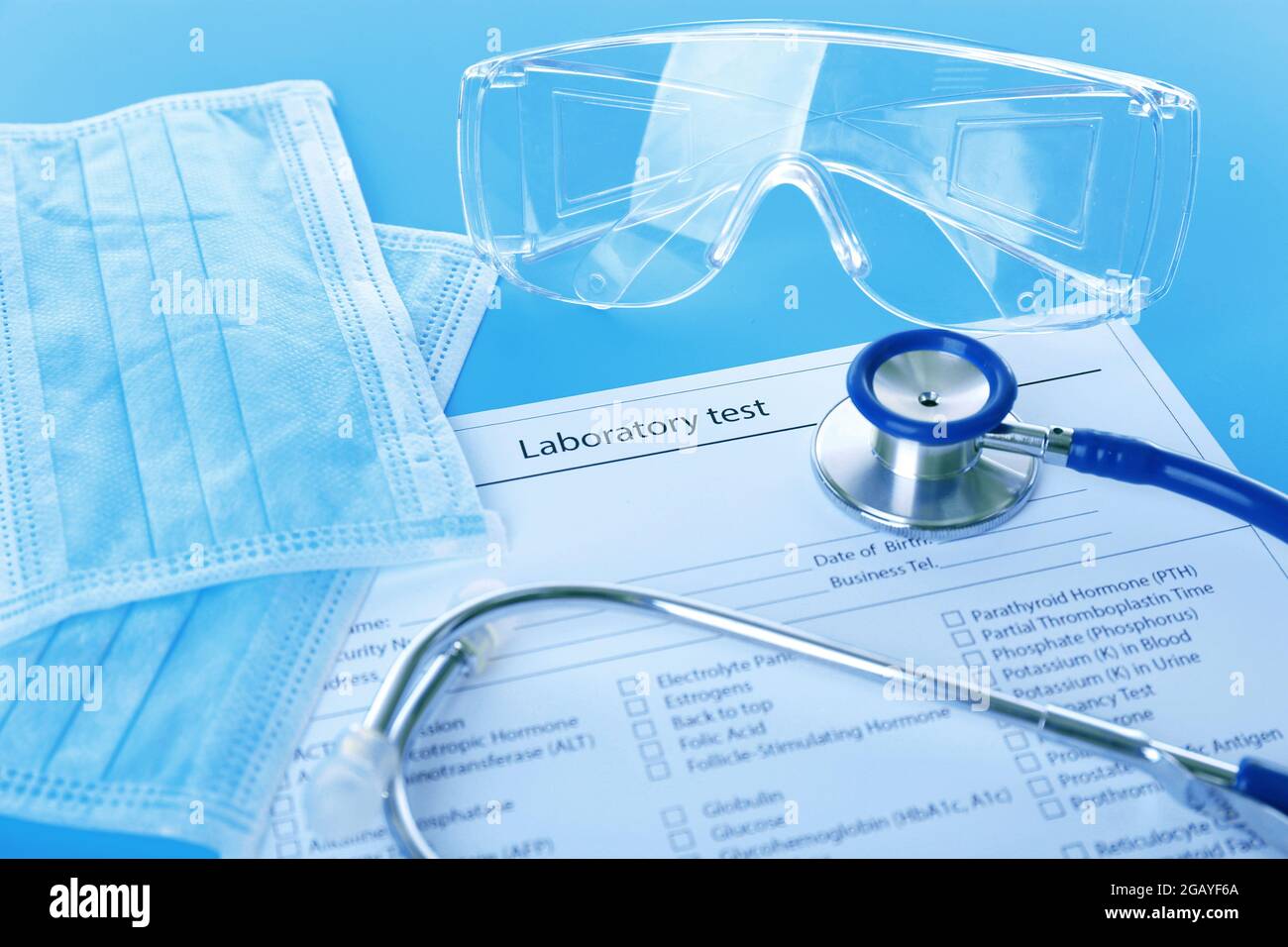 Laboratory test list, stethoscope and eyeglasses on blue background ...