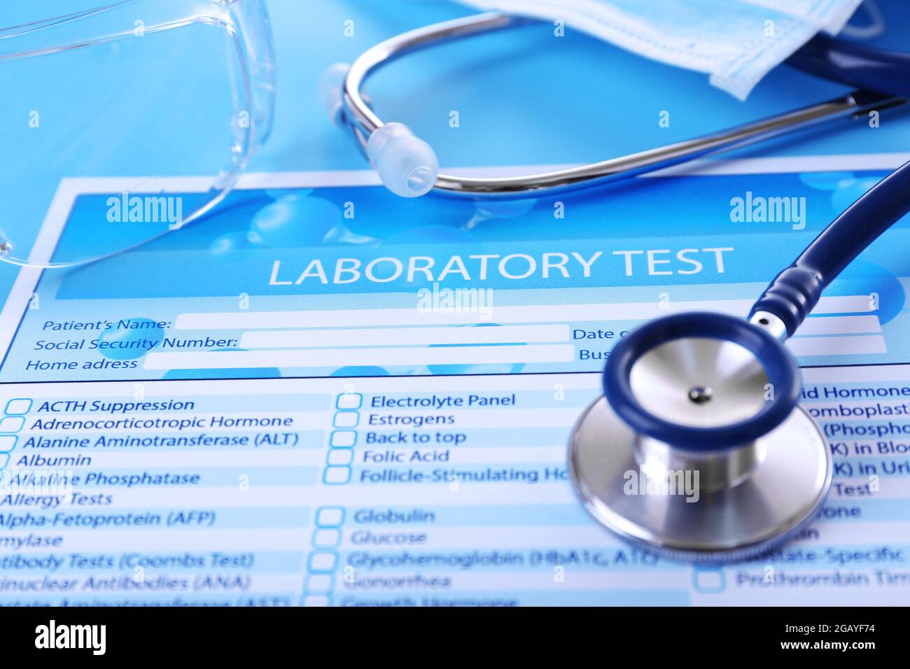 Laboratory test list, stethoscope and eyeglasses on blue background ...
