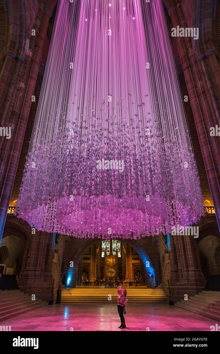 A woman seen taking a picture of the Peace Doves art installation seen ...