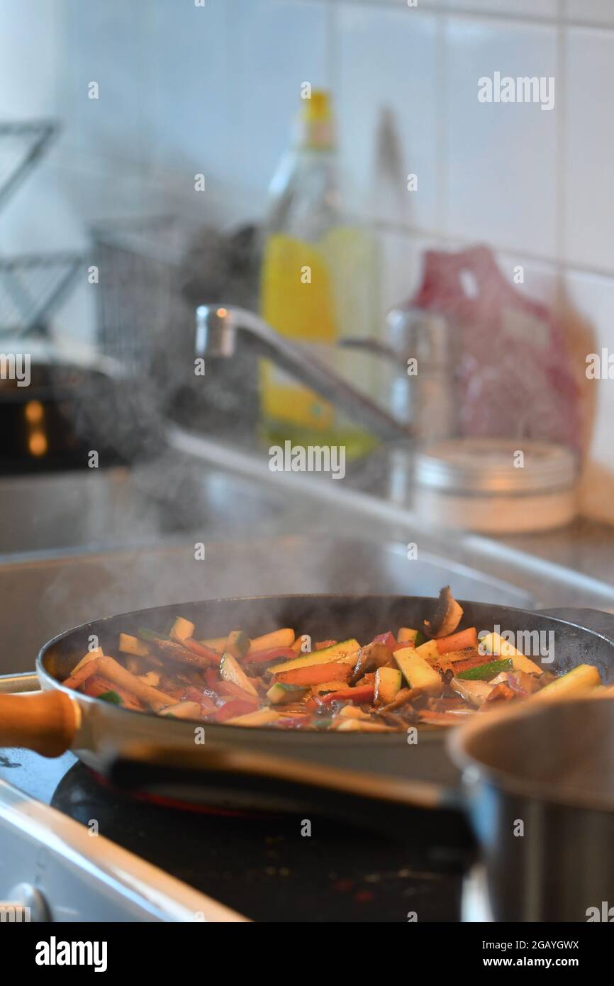 Photo of food being cooked in kitchen, frying vegetables in pan Stock ...