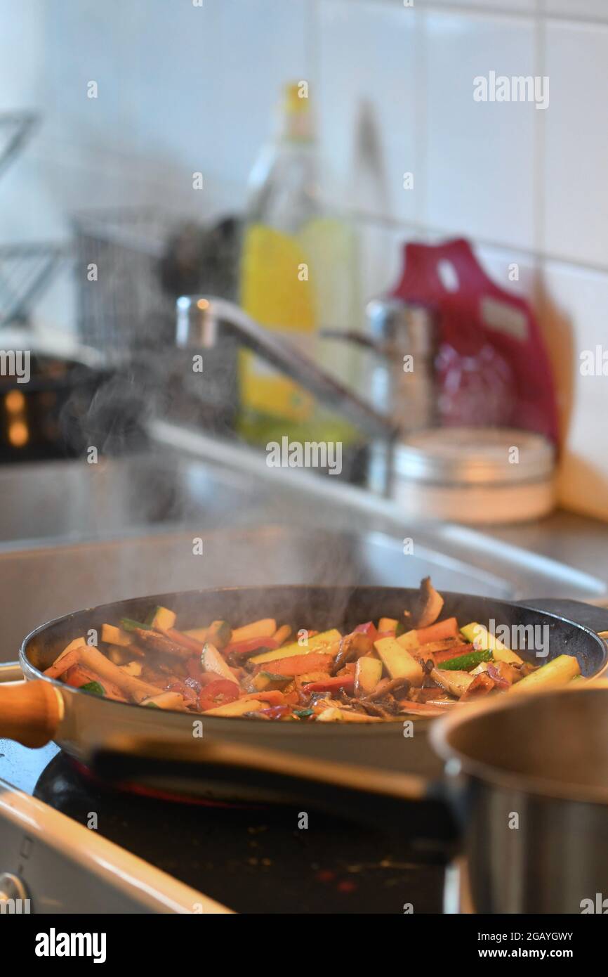 Photo of food being cooked in kitchen, frying vegetables in pan Stock ...