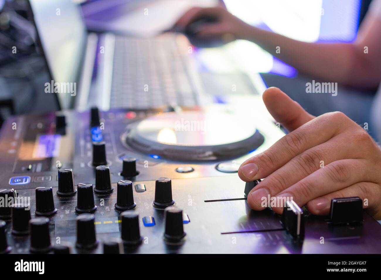 DJ controls a remote at a club party Stock Photo - Alamy