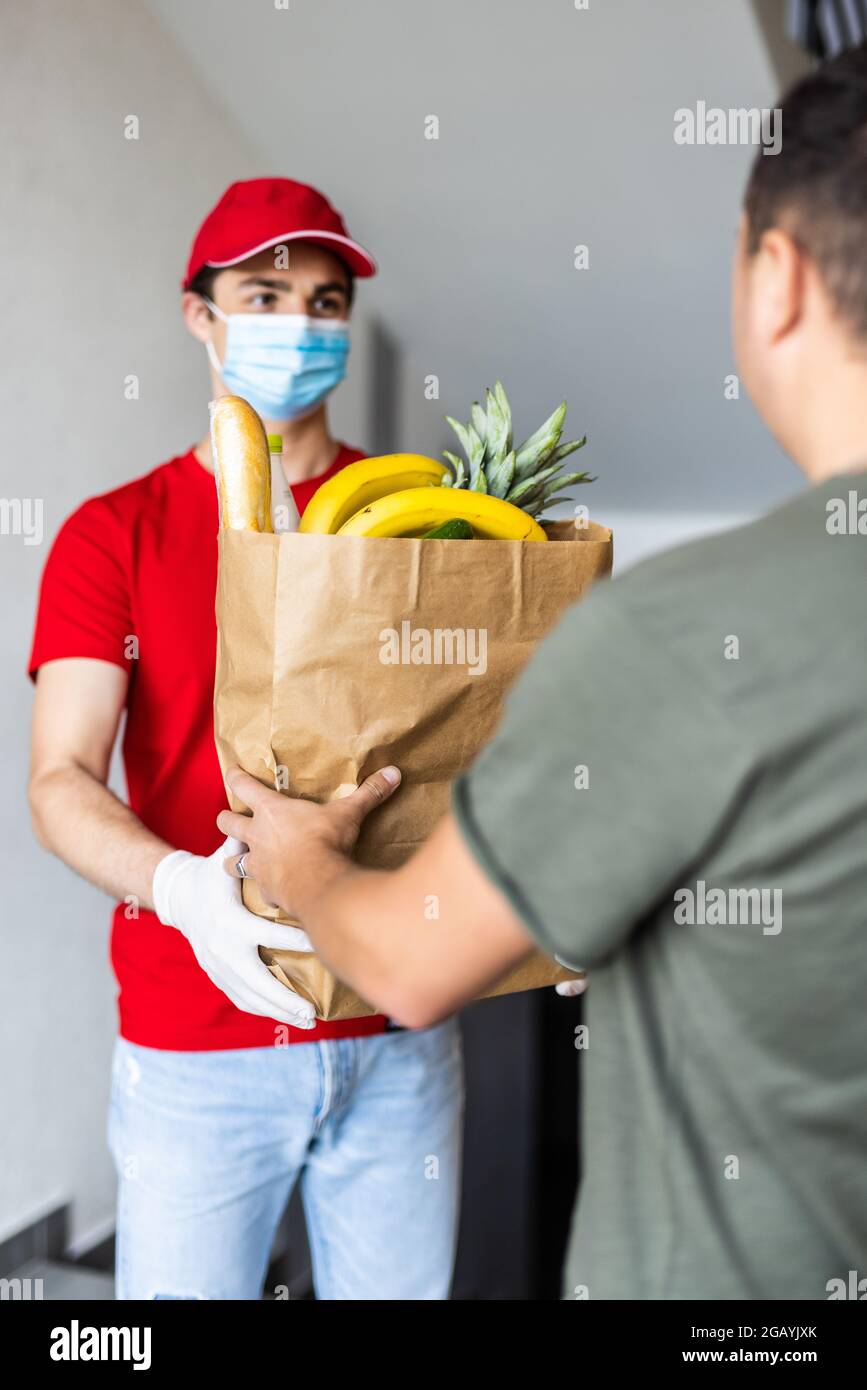 online grocery shopping service concept - delivery man with food box ...