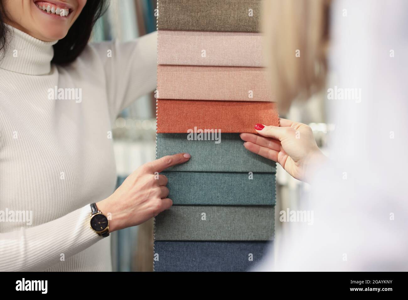 Woman consultant shows buyer different fabrics to choose from Stock ...