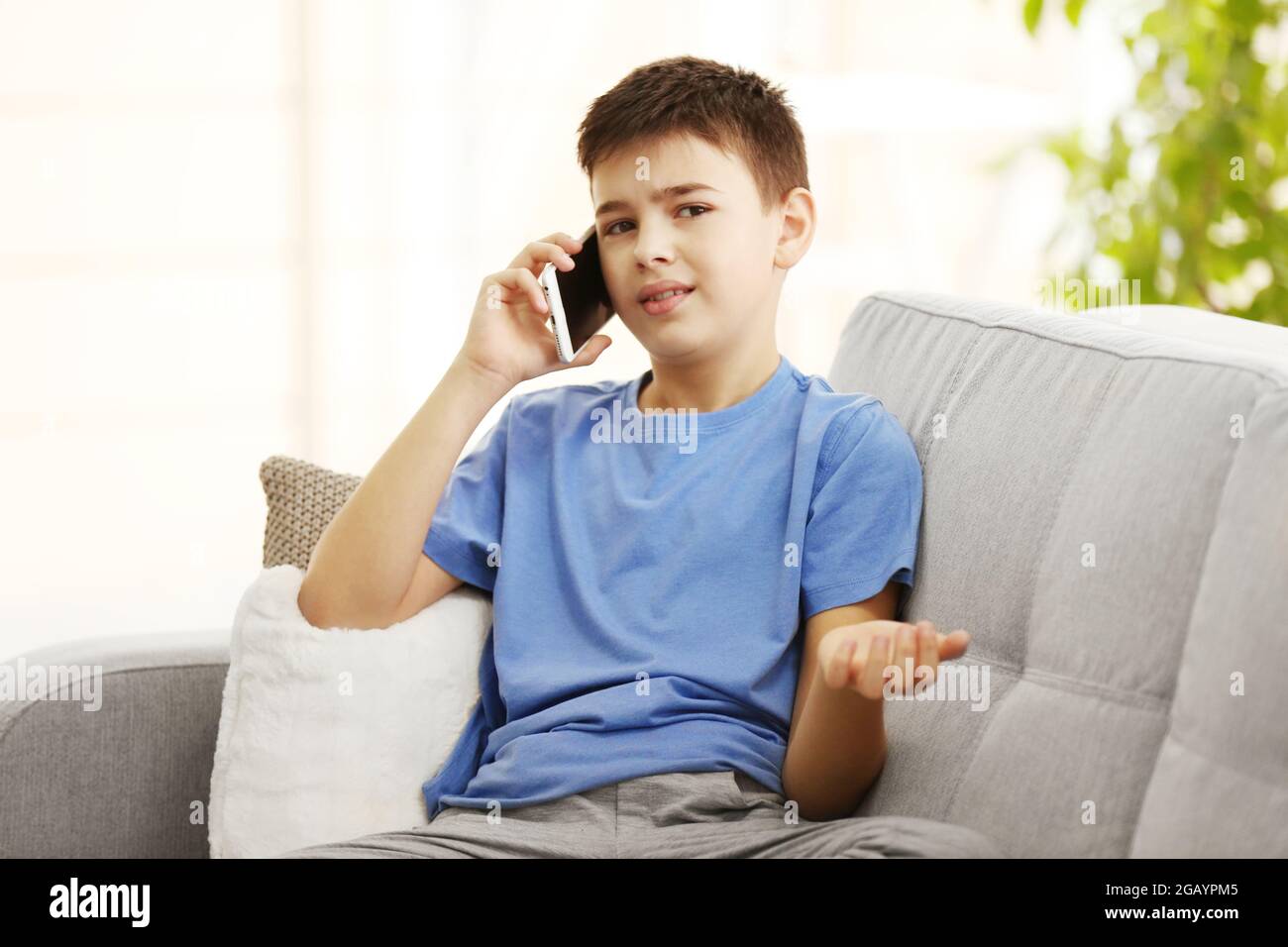 Boy using his mobile phone at home Stock Photo - Alamy
