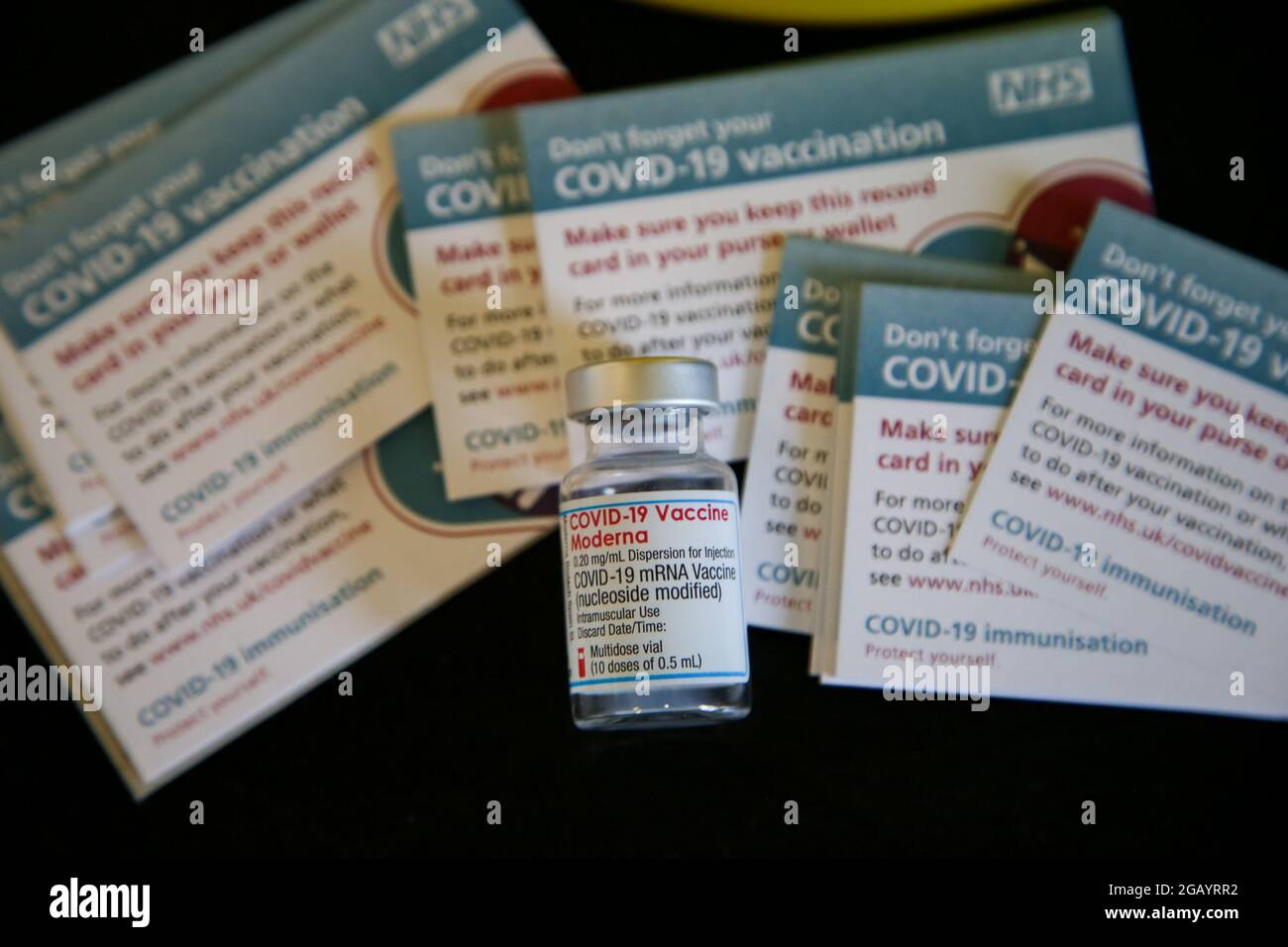 In this photo illustration, a vial containing Moderna Covid-19 vaccine ...