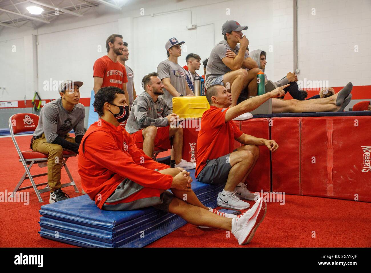 Rustam Sharipov (C) reacts as they watch the Men’s Pommel Horse finals ...