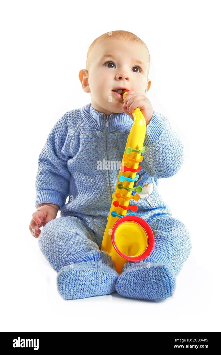 Adorable baby with plastic colourful saxophone isolated on white ...