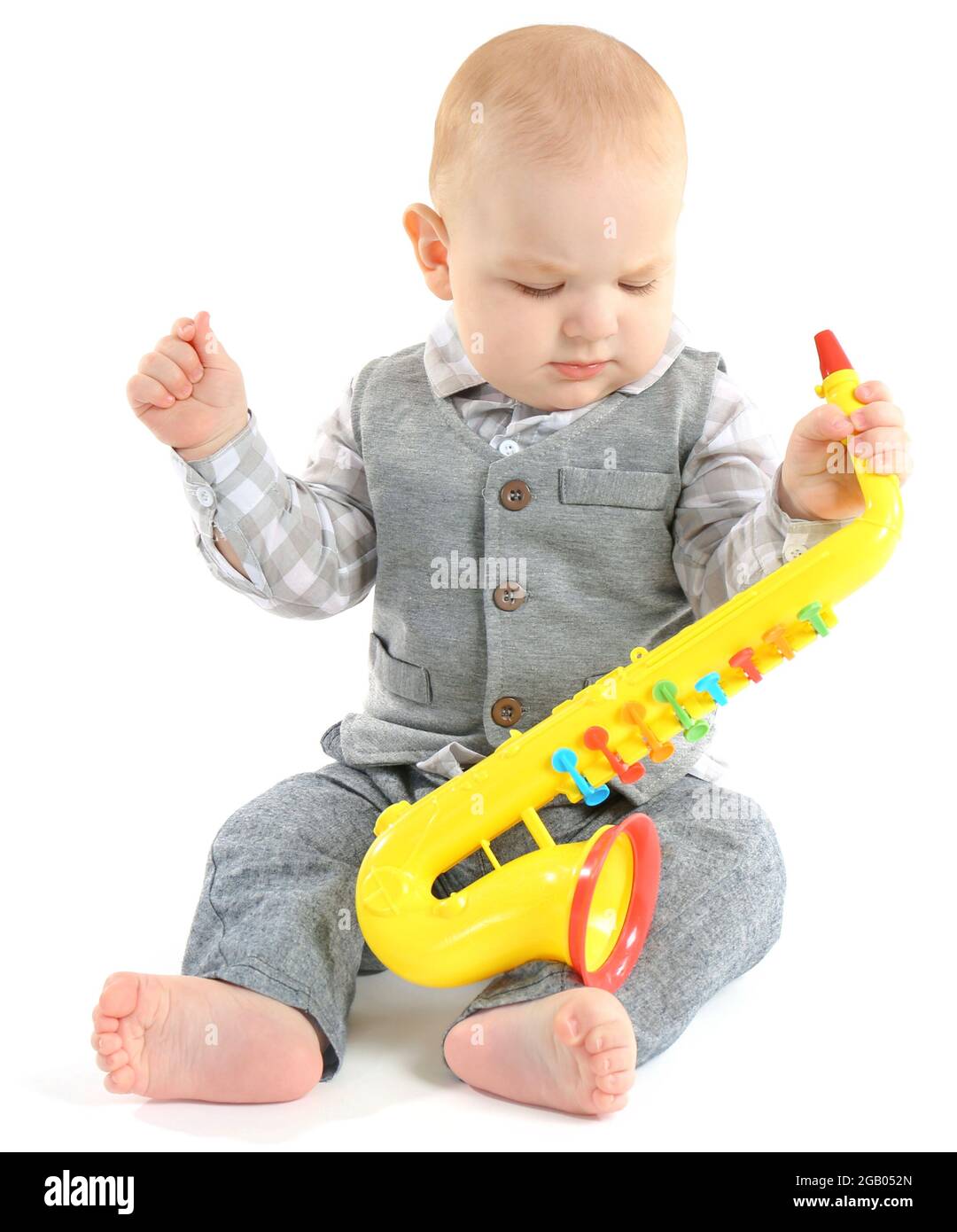 Adorable baby with plastic colourful saxophone isolated on white ...