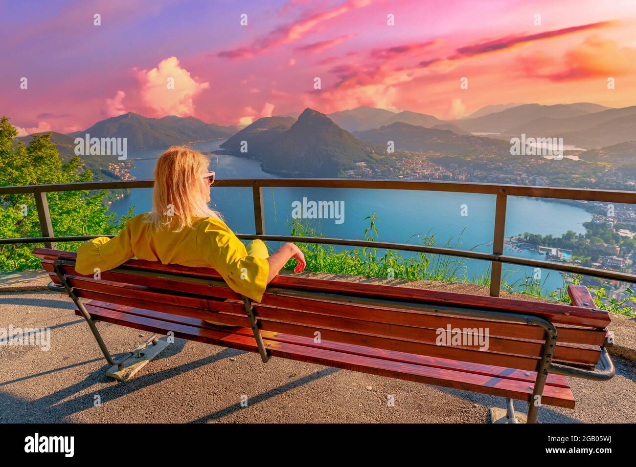 elegant woman sitting on top bench of Lugano city by Lugano Lake in ...