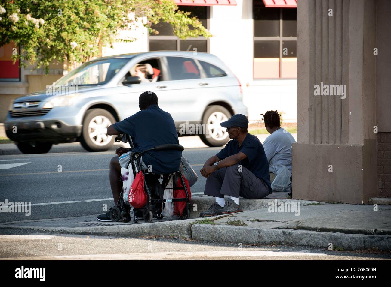 Tampa, Florida, USA. 1st Aug, 2021. Homeless men pass the time along a ...