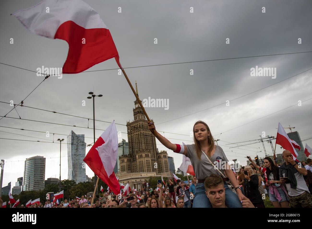Participants of the Warsaw Uprising march wave Polish flags during the ...