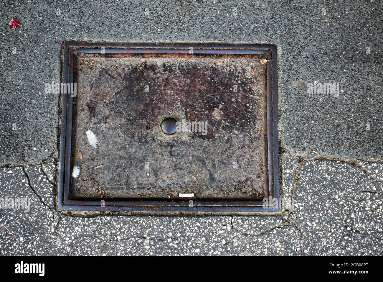 Square hatch for communications on an urban asphalt road. Close-up ...