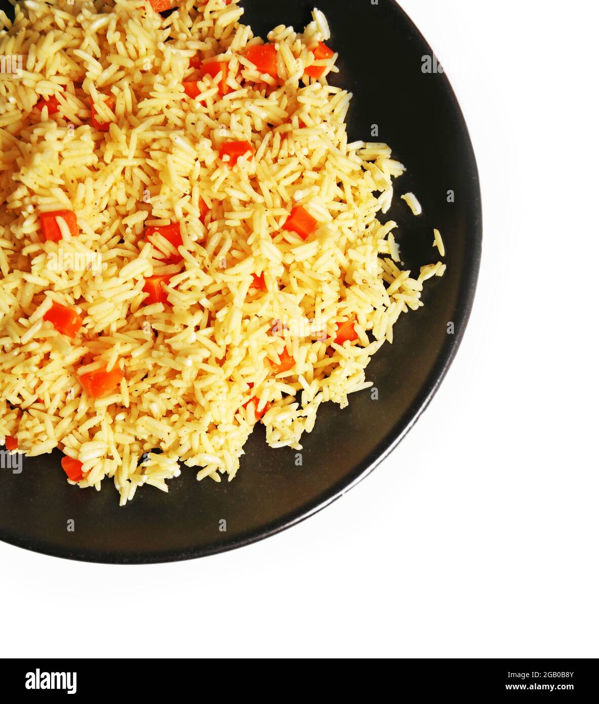 Stewed rice with a carrot on a black plate over white background Stock ...