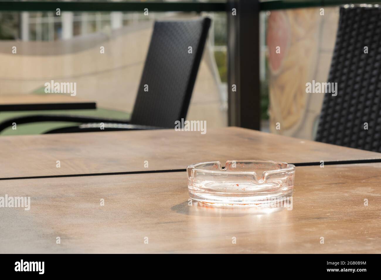Glass ashtray box on the table at the restaurant Stock Photo - Alamy
