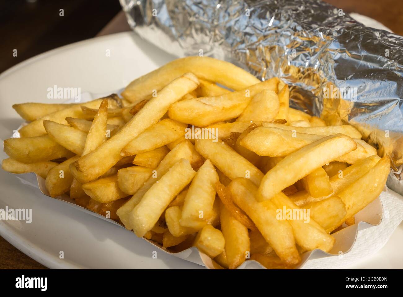 Kebab and French fries recipe on a white dish table in an European ...
