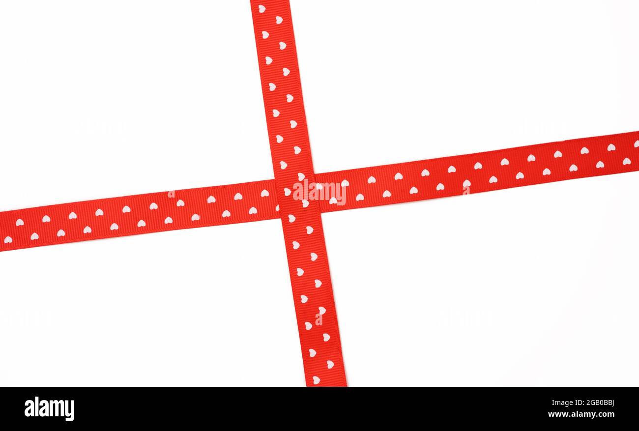 red satin ribbon cross to cross on white background, gift wrapping ...