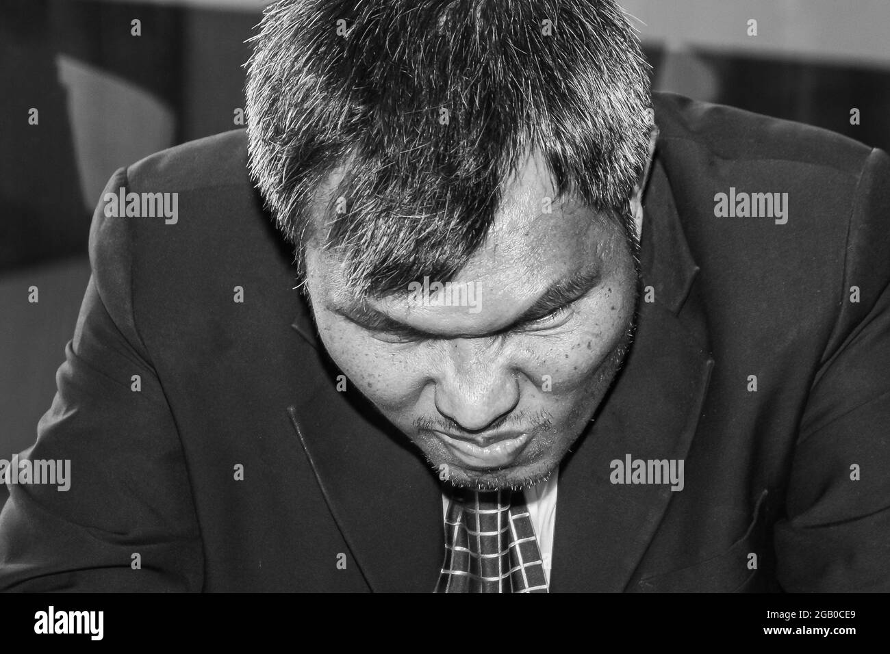 An Asian male businessman is sad and crazy upset for his failure ...