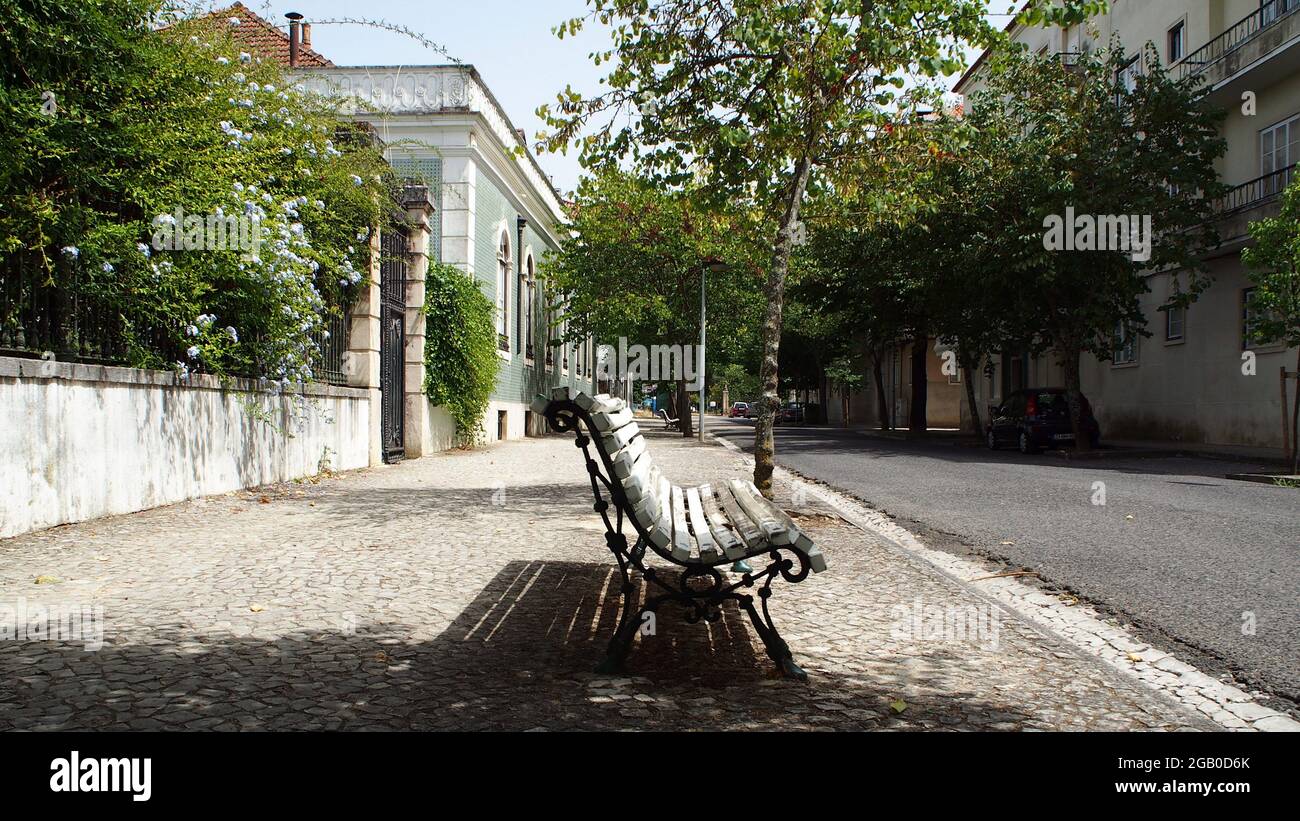 Old-fashioned street bench on a cobblestone sidewalk of the Avenue of ...