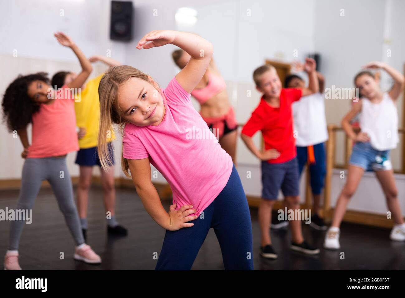 Girl doing stretching exercises before dance training Stock Photo - Alamy