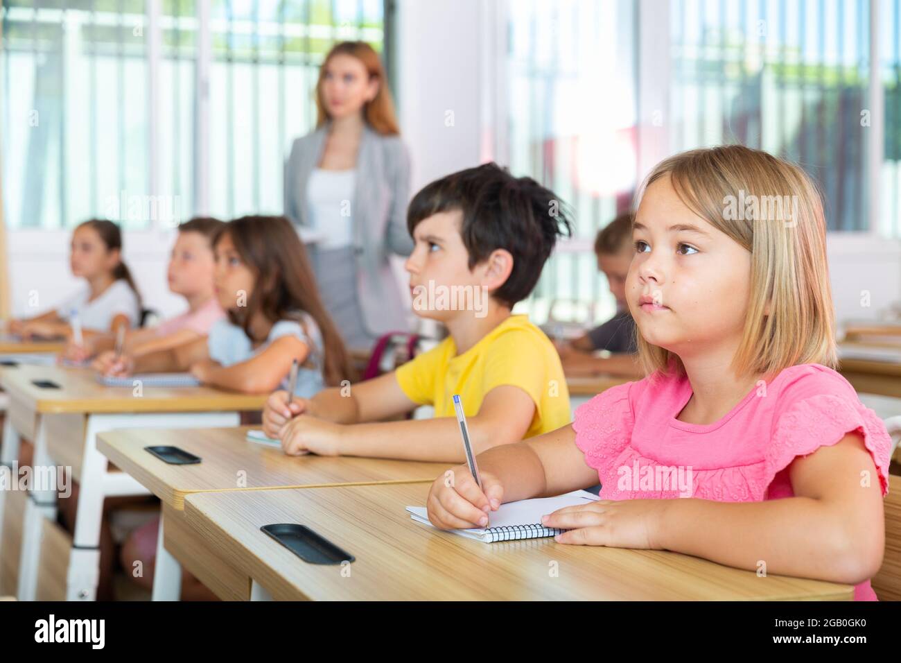Kids studying in classroom Stock Photo - Alamy