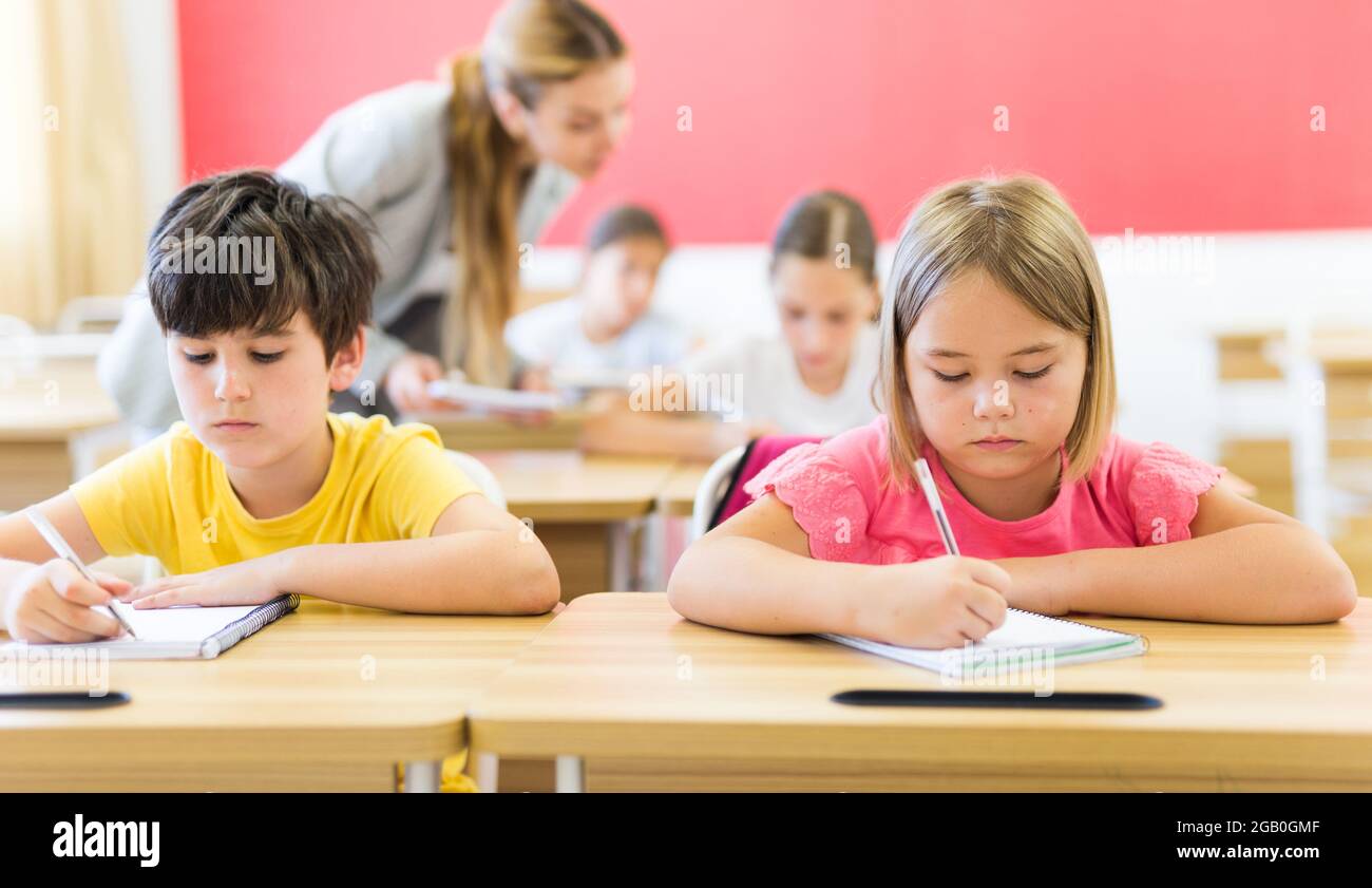 Kids sitting in classroom Stock Photo - Alamy