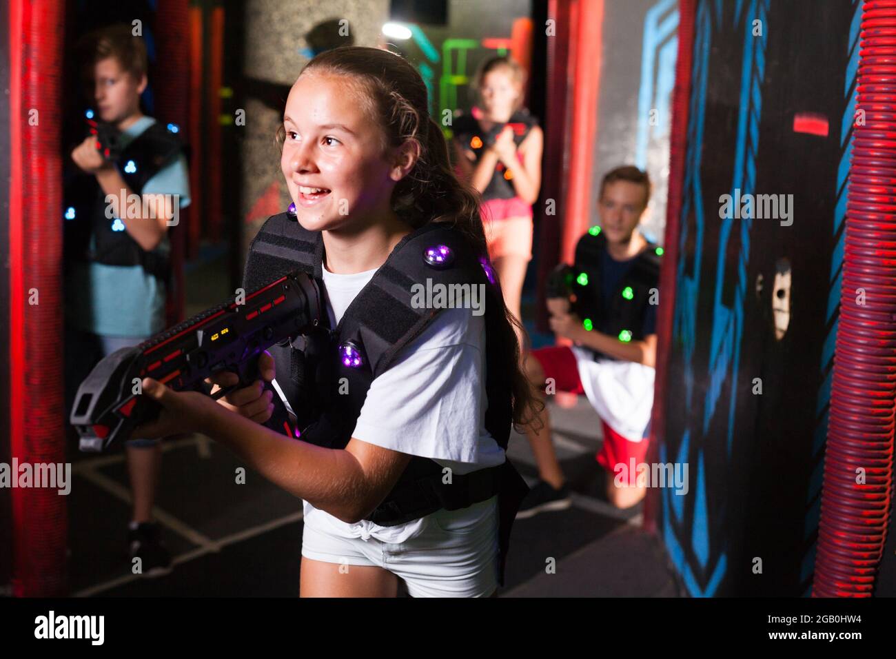 Girl playing laser tag Stock Photo - Alamy
