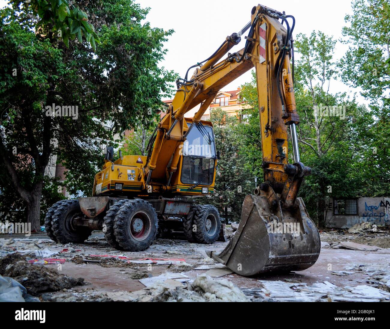 Excavator cleans the construction surface from concrete pieces Stock ...