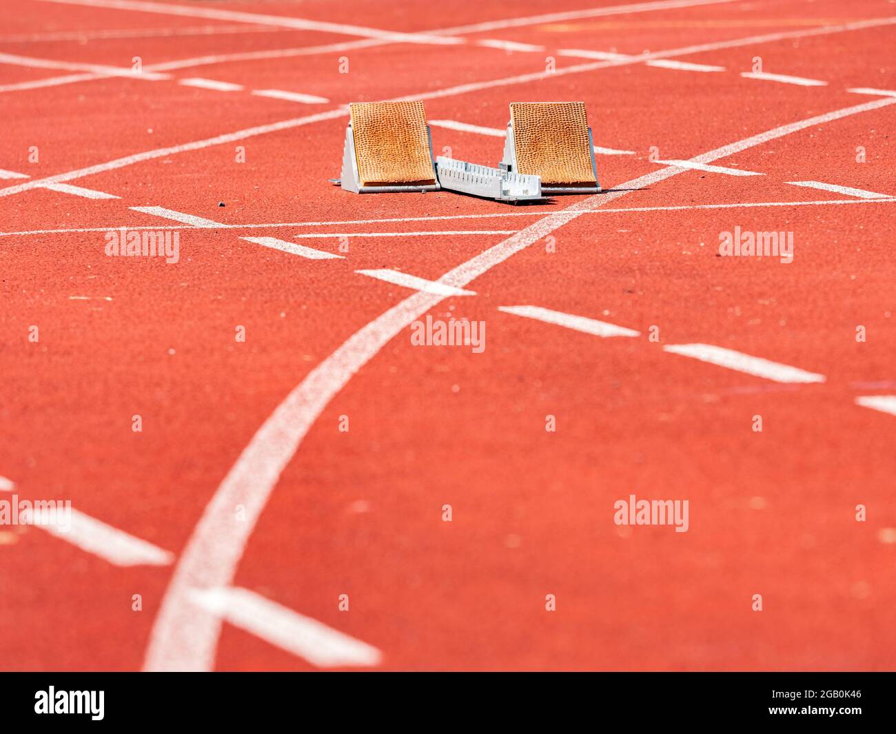 Empty Starting Blocks and red running tracks in a stadion. Athletic ...