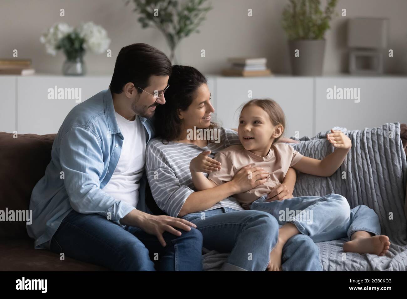 Happy excited daughter girl talking to engaged parents Stock Photo - Alamy