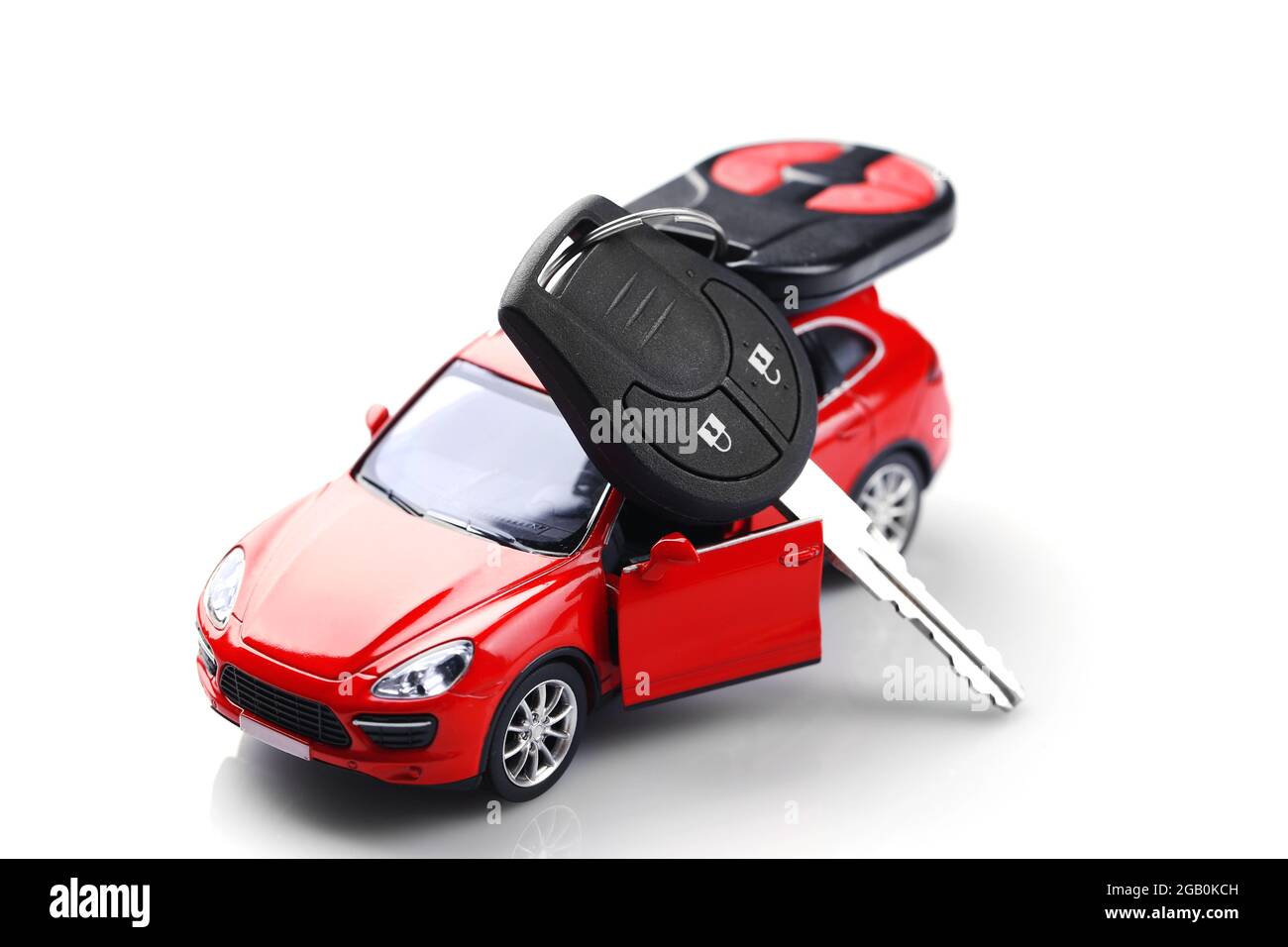 Little red car with key isolated on white background Stock Photo - Alamy