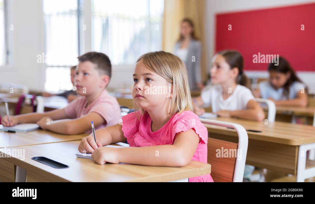 Kids studying in classroom Stock Photo - Alamy