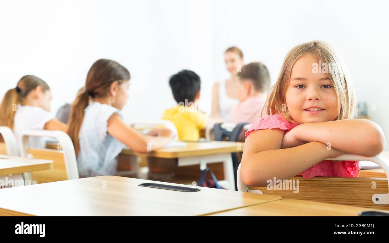 Schoolgirl sitting in classroom Stock Photo - Alamy