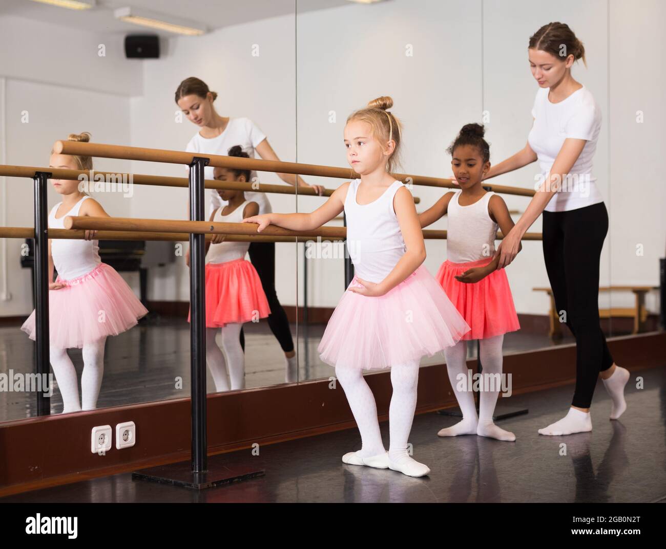 Ballet trainer teaching two little girls Stock Photo - Alamy