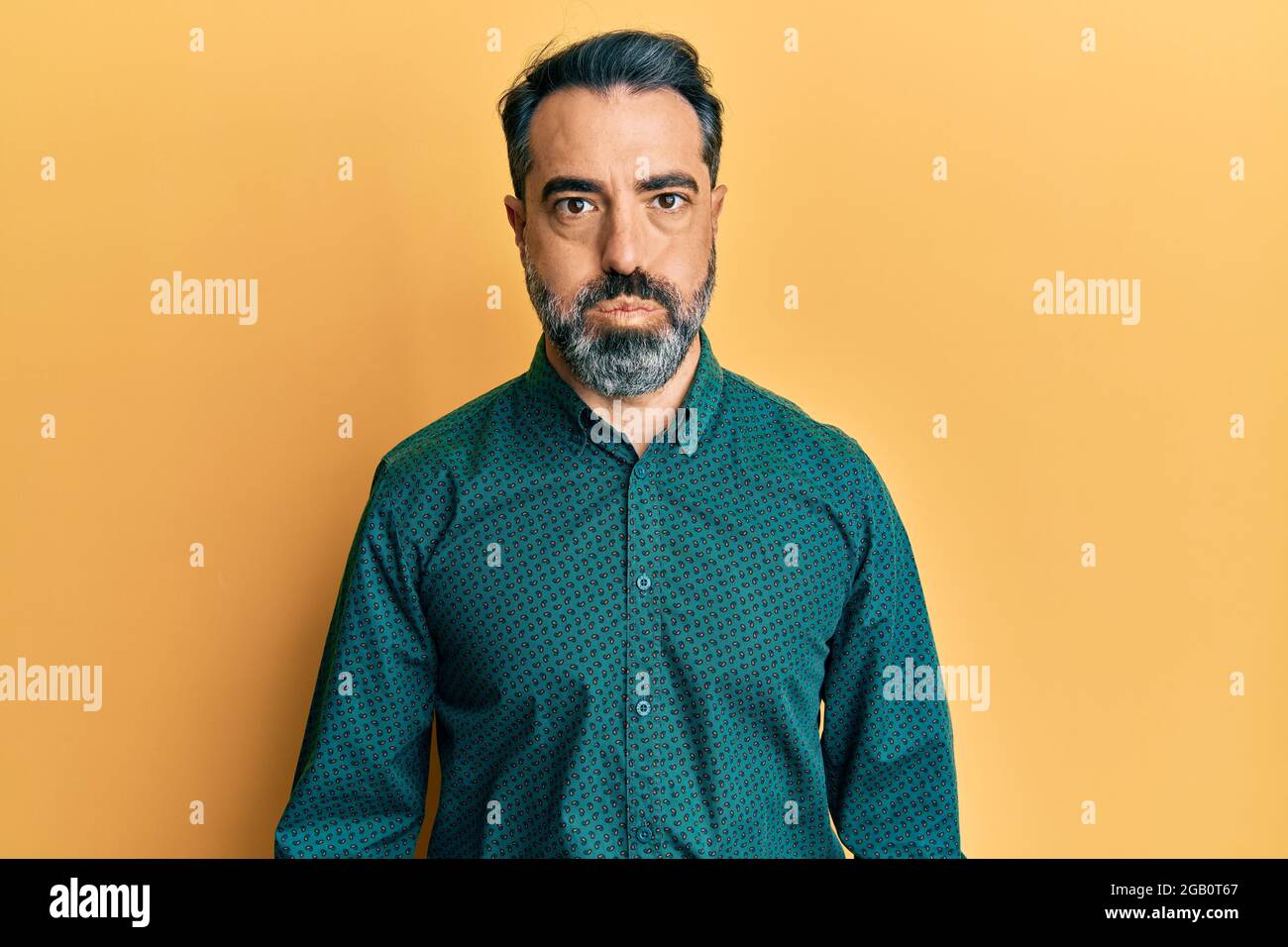 Middle age man with beard and grey hair wearing business clothes ...