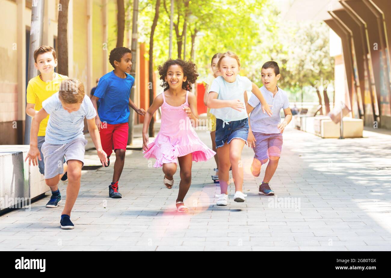 Happy children running in race and laughing outdoors Stock Photo - Alamy