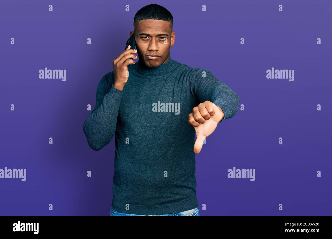 Young black man having conversation talking on the smartphone with ...