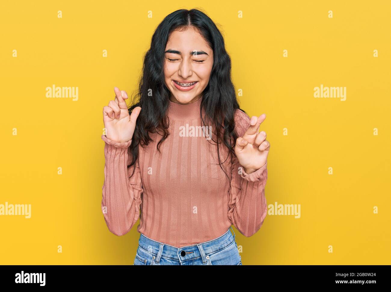 Hispanic teenager girl with dental braces wearing casual clothes ...