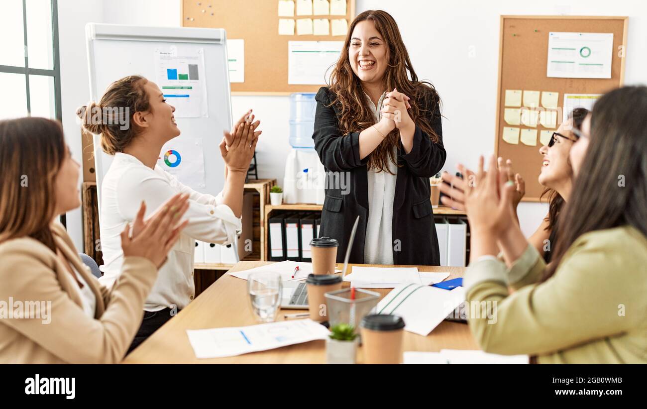 Group of young businesswomen smiling and clapping to partner at the ...