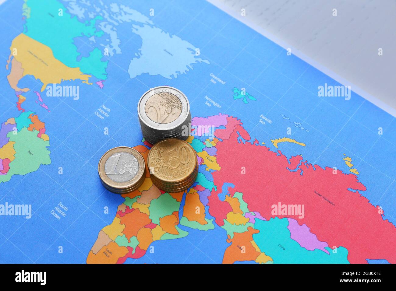 Euro coins on map background Stock Photo - Alamy