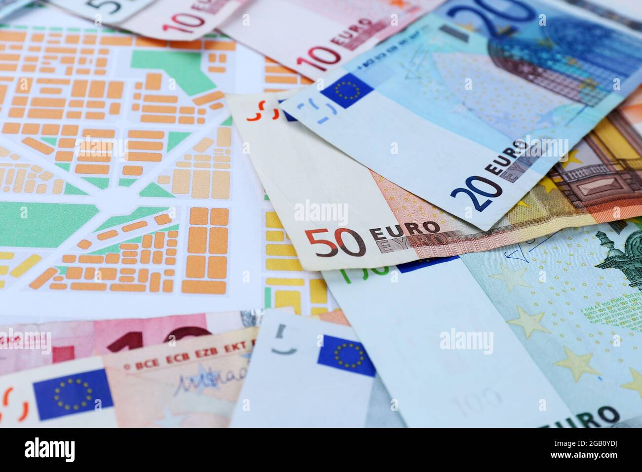 Different euro banknotes on a map background Stock Photo - Alamy