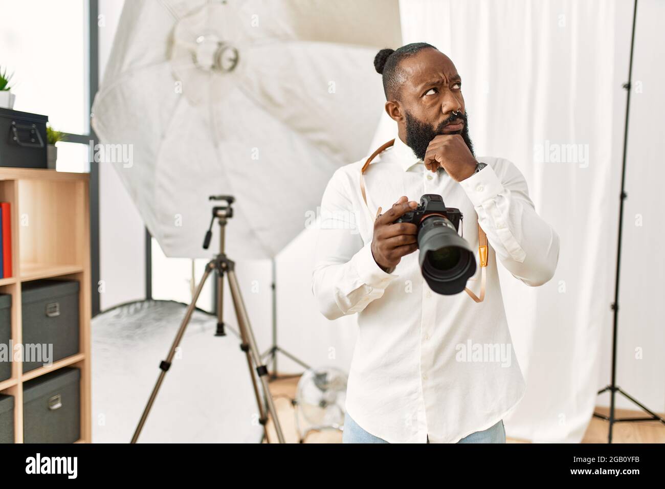 African american photographer man working at photography studio with ...
