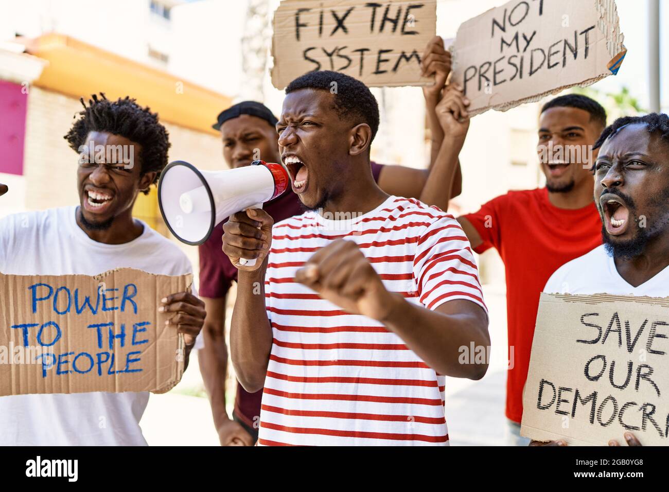 Group of young african american activists protesting holding banner and ...