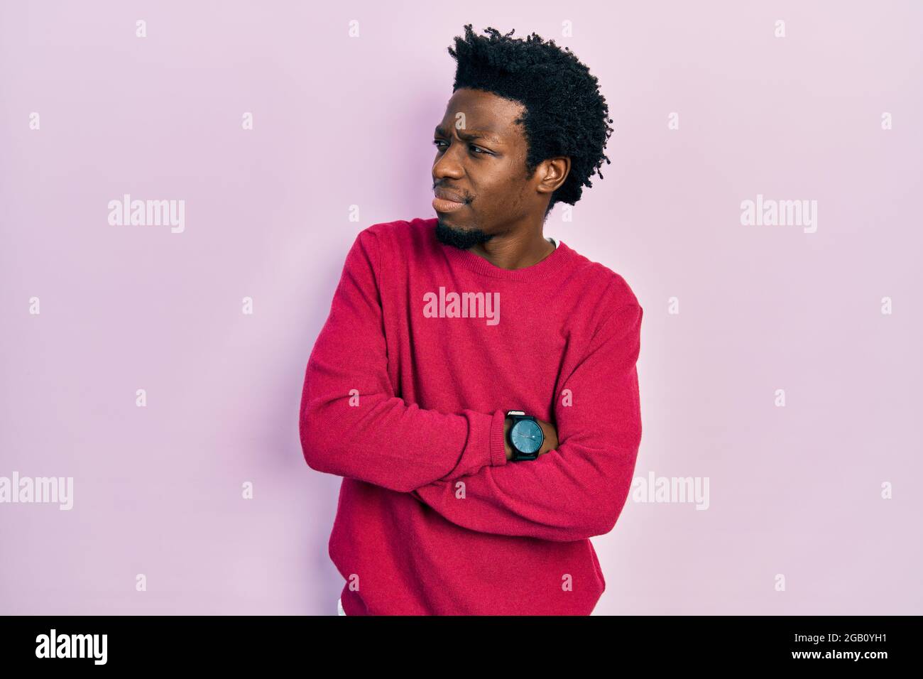 Young african american man wearing casual clothes looking to the side ...