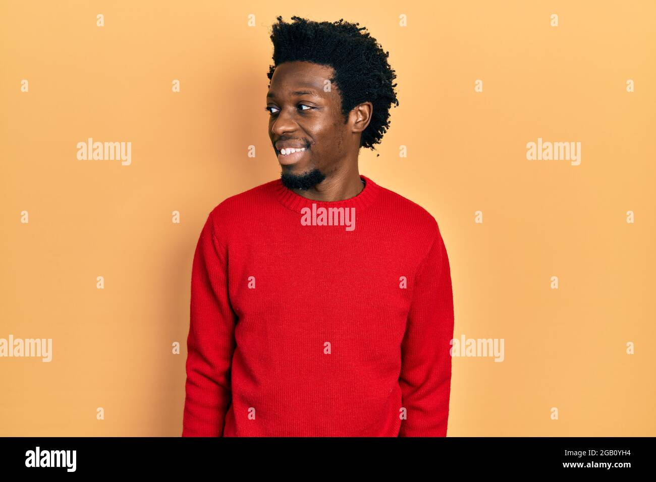 Young african american man wearing casual clothes looking to side ...