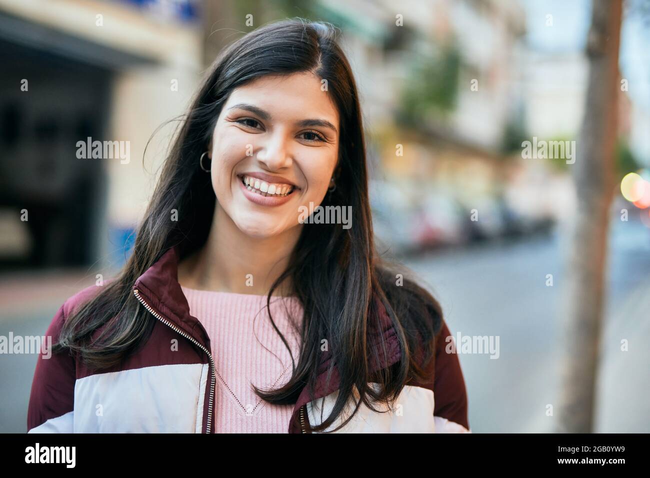 Young hispanic girl smiling happy standing at the city Stock Photo - Alamy